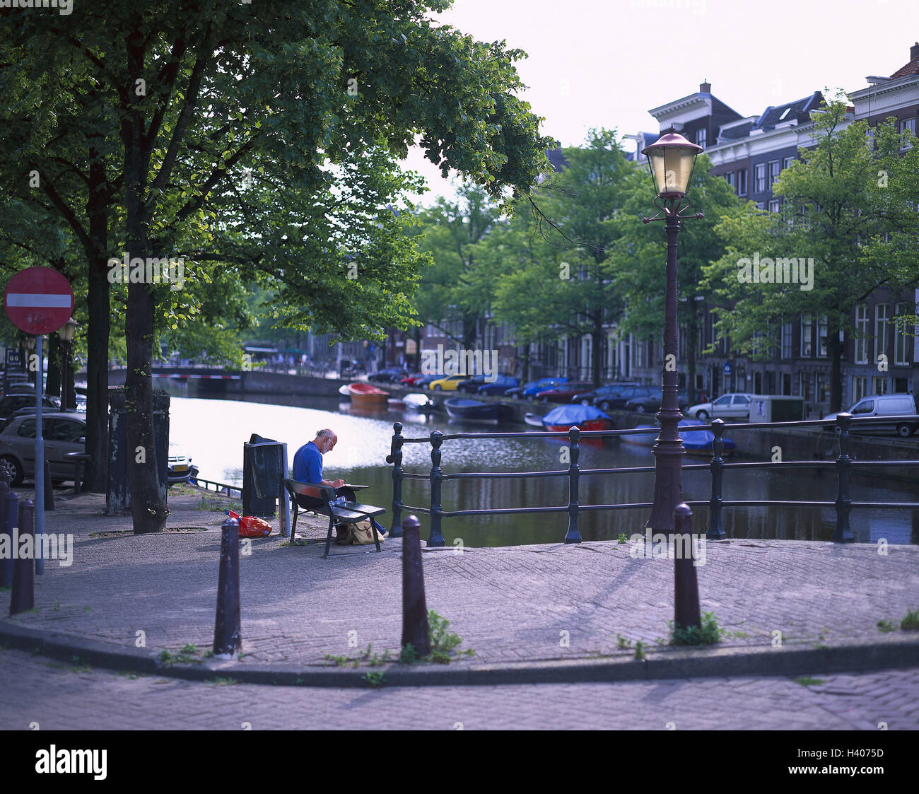 The Netherlands, Amsterdam, town view, channel, park-bench, senior ...