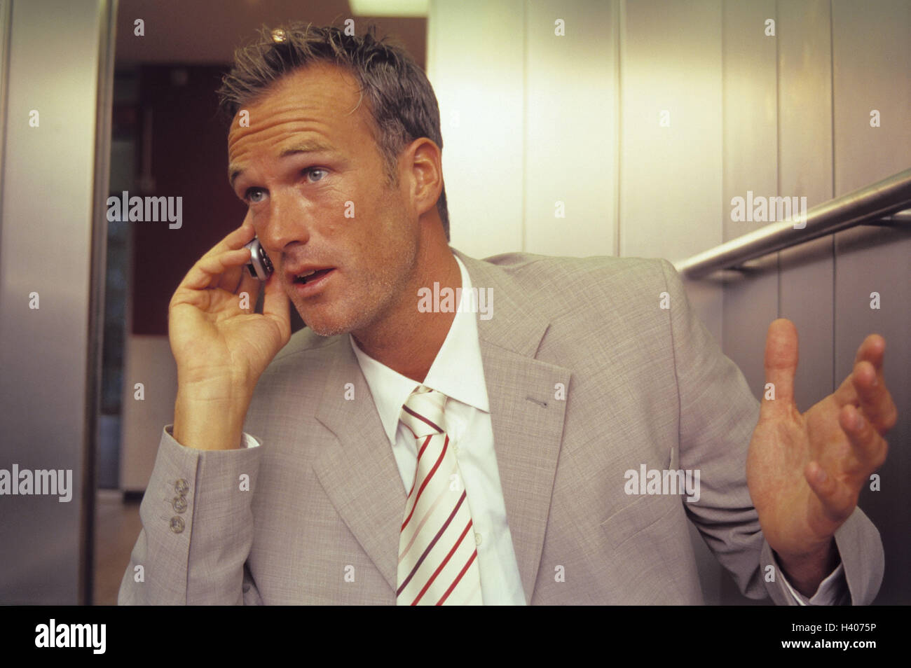 Lift, man, suit, mobile phone, call up, lean gesture, seriously lift ...