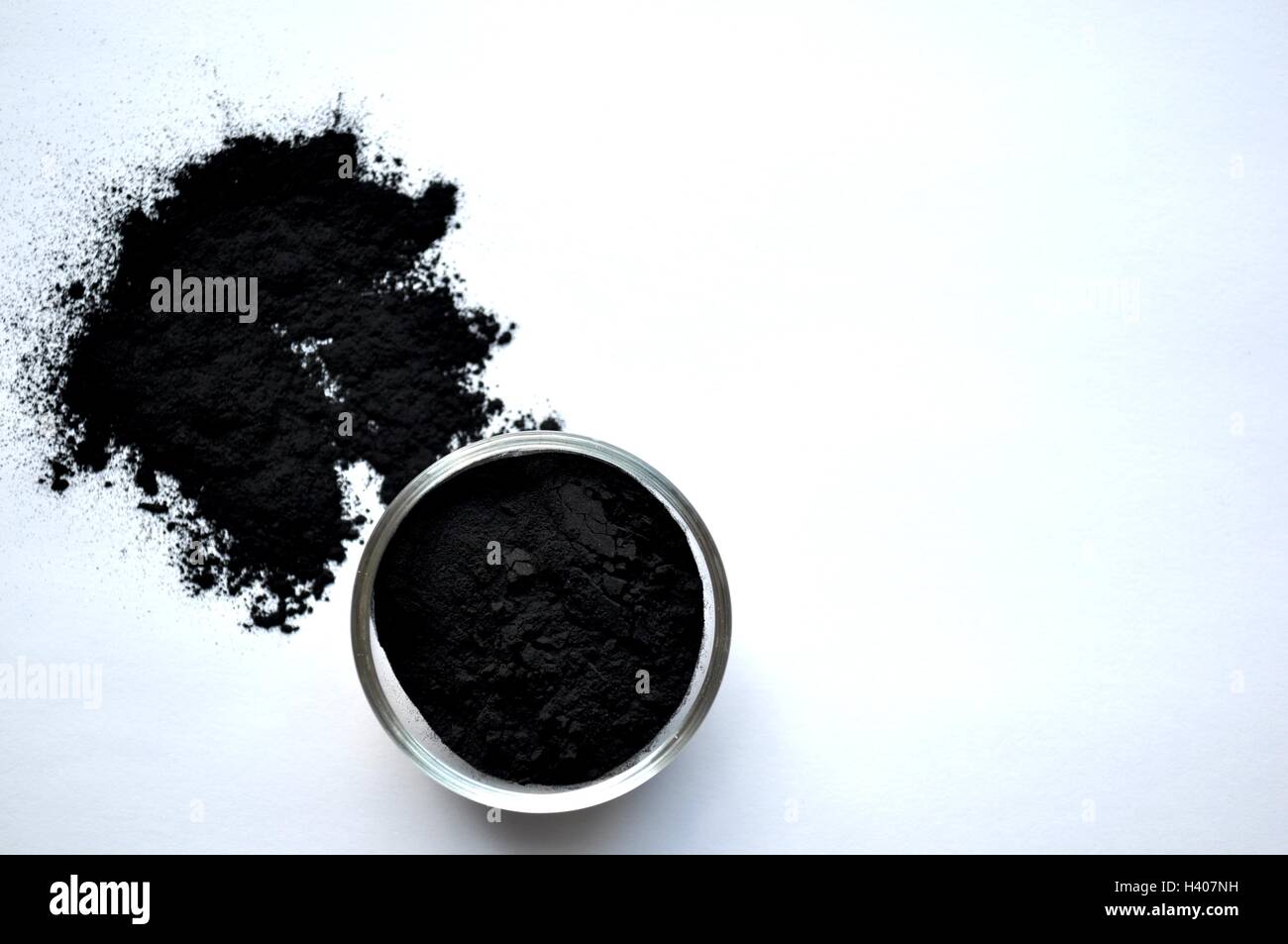 Powdered black activated charcoal for cosmetic facial masks, top view ...