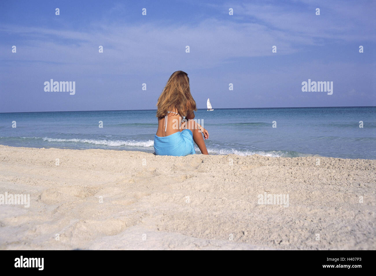 Cuba, sandy beach, woman, sit, enjoy view sea, back view from the ...