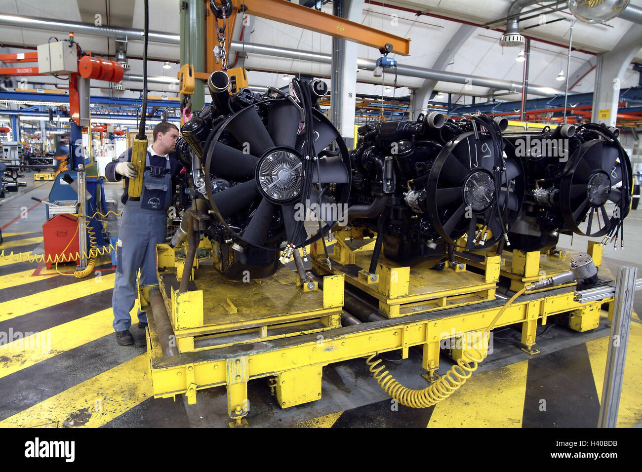 One truck production, factory building, worker, truck engines ...