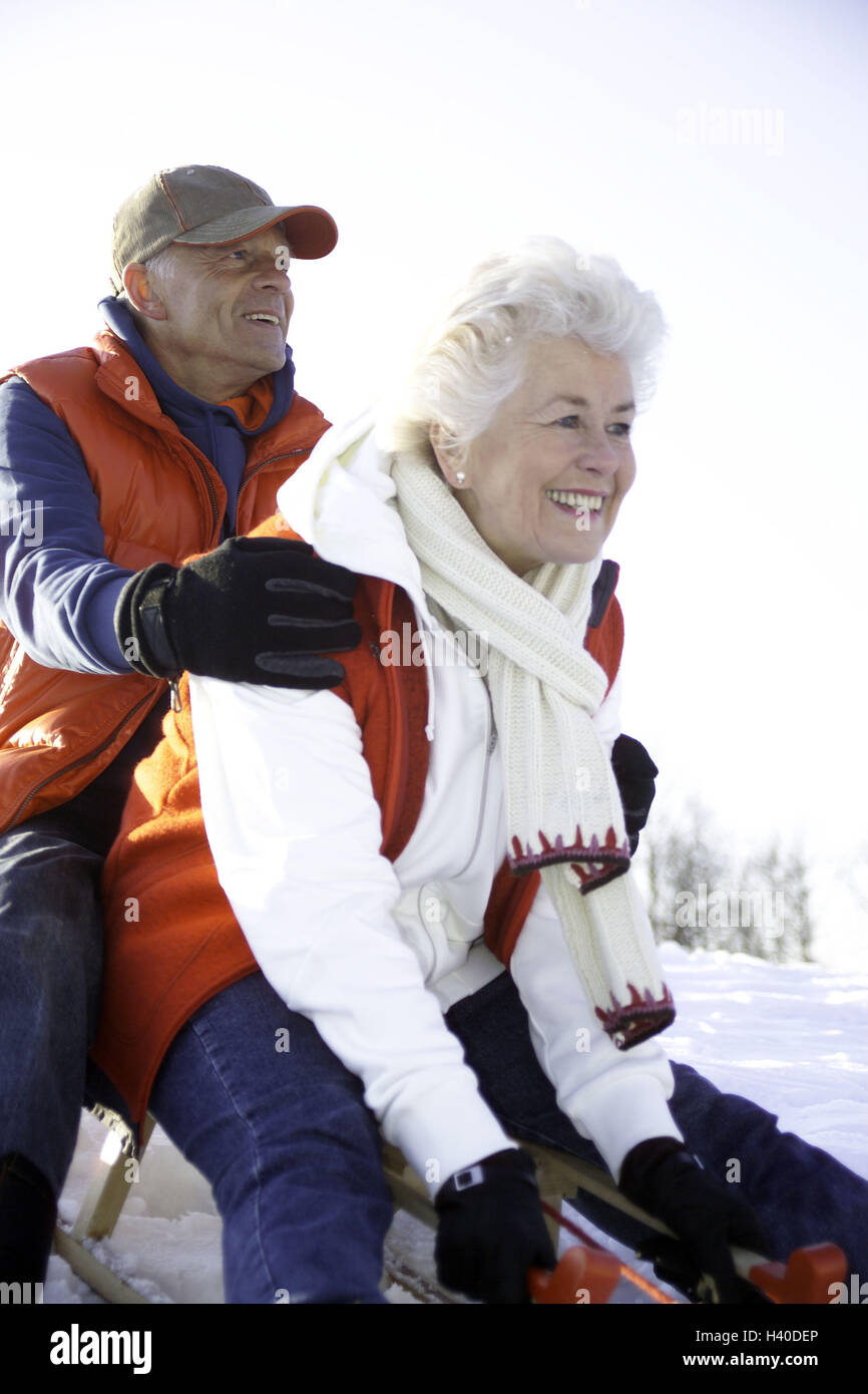Senior couple, sleigh-riding, happy, curled, 60-70 years, senior ...