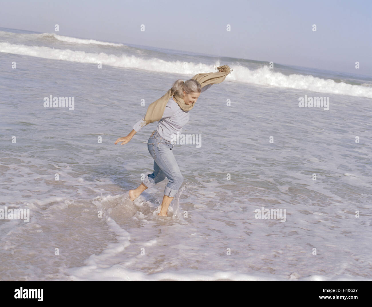 Sandy beach, sea, senior, happy, water shallowly, run, enjoy side view ...