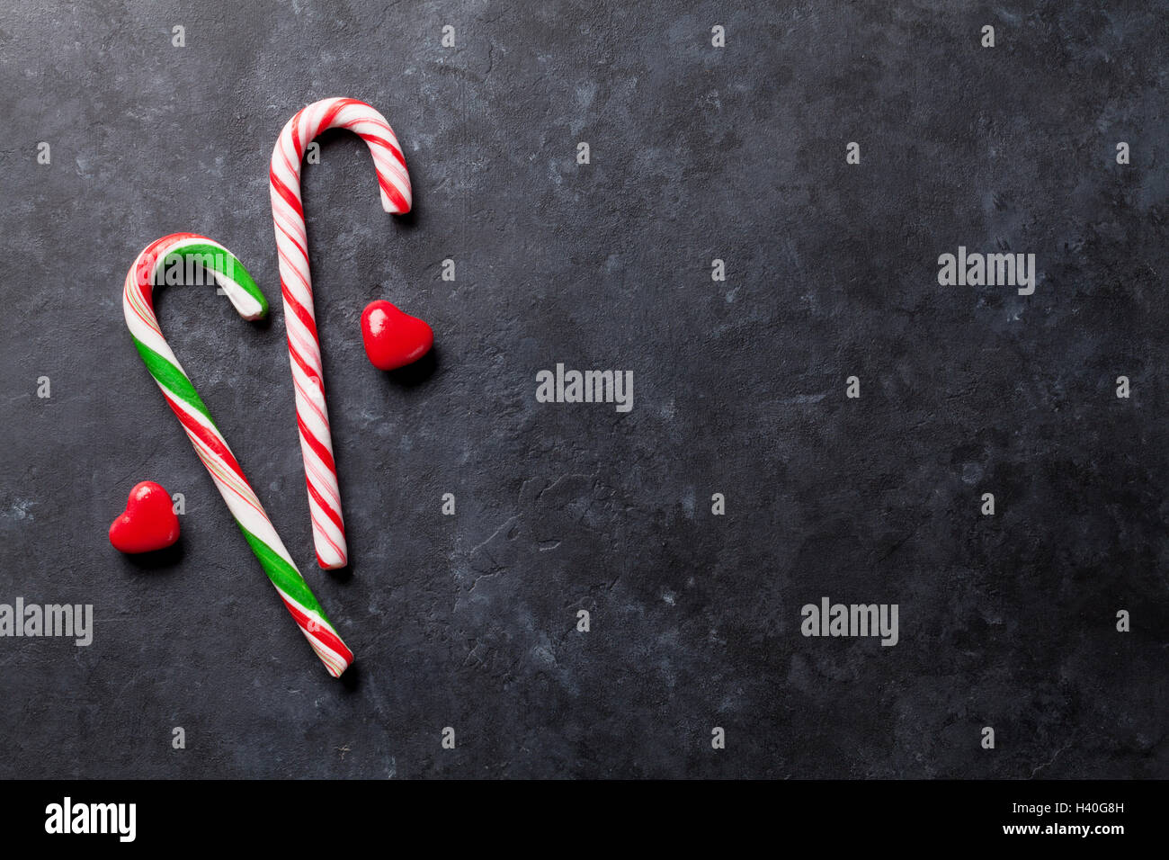 Candy canes over stone background. Top view with copy space Stock Photo ...