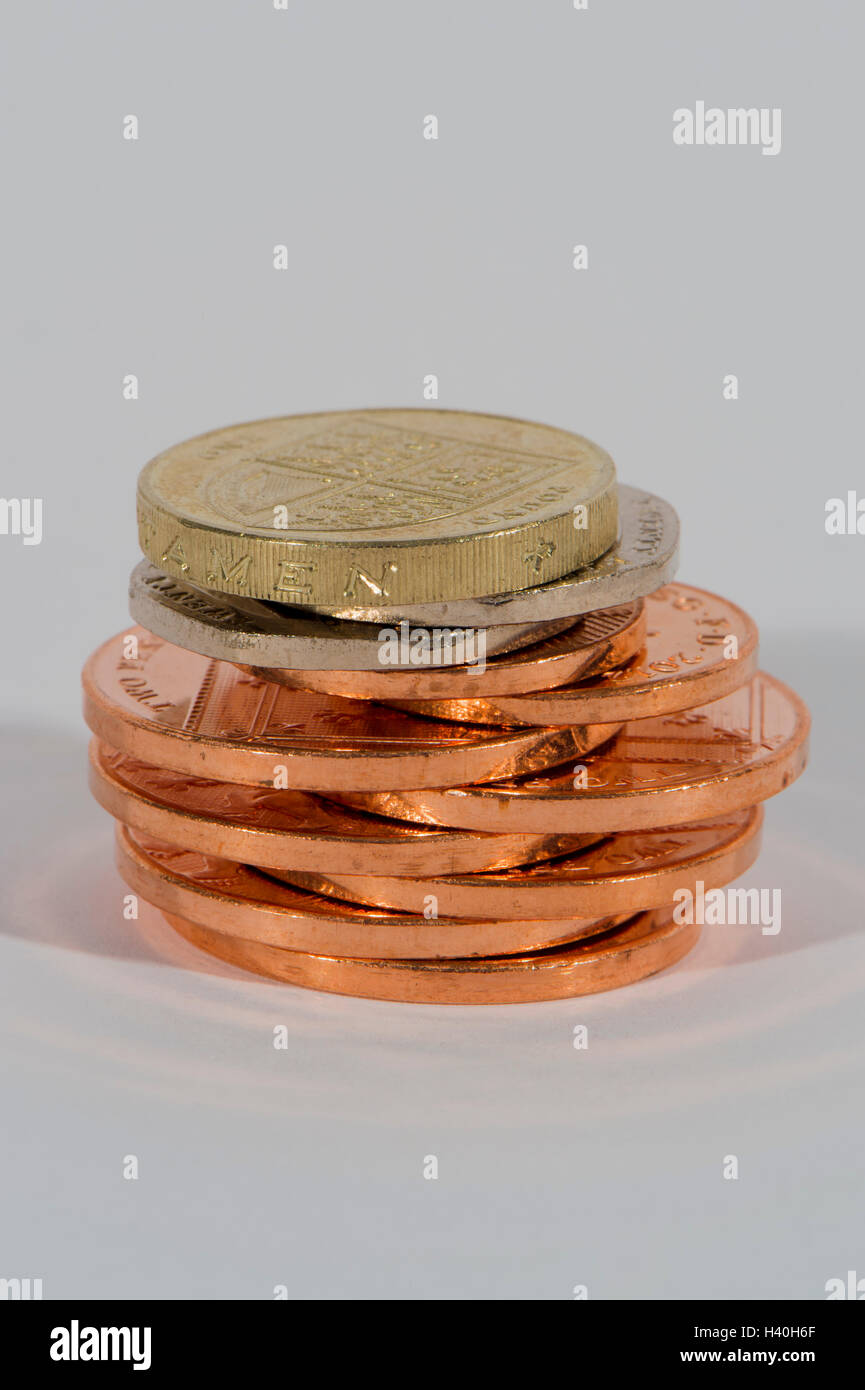 Stack of shiny, copper and silver coins ( 2p, 20p, £1) seen in close-up ...
