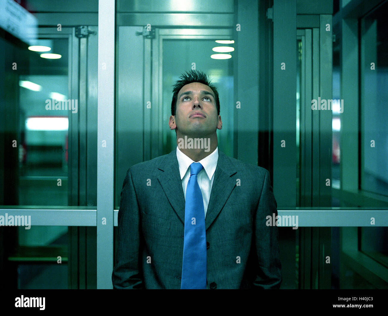 Railway station, elevator, man, suit, gaze upwards, half portrait Stock ...