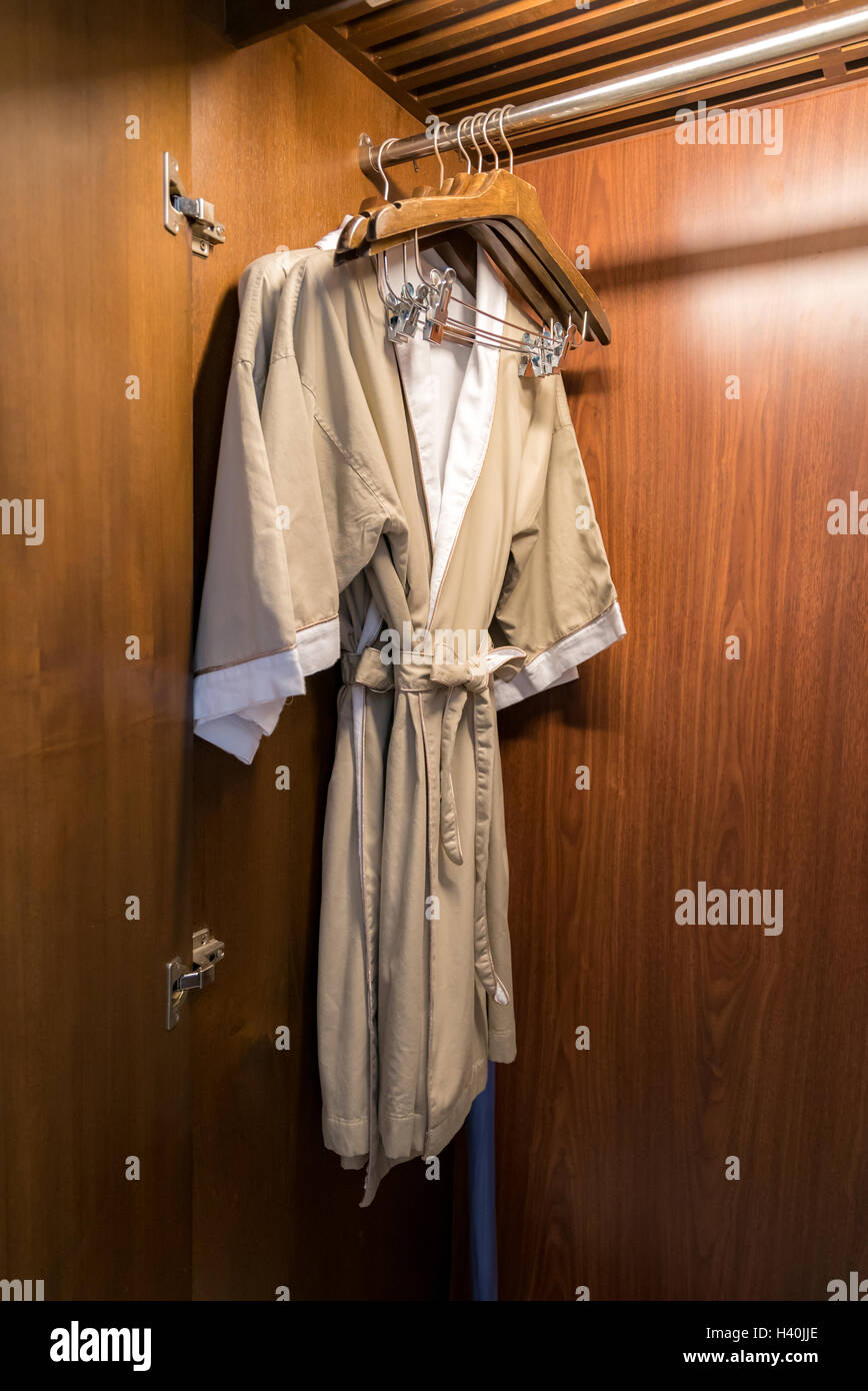 bathrobe with wooden hangers in wardrobe Stock Photo - Alamy