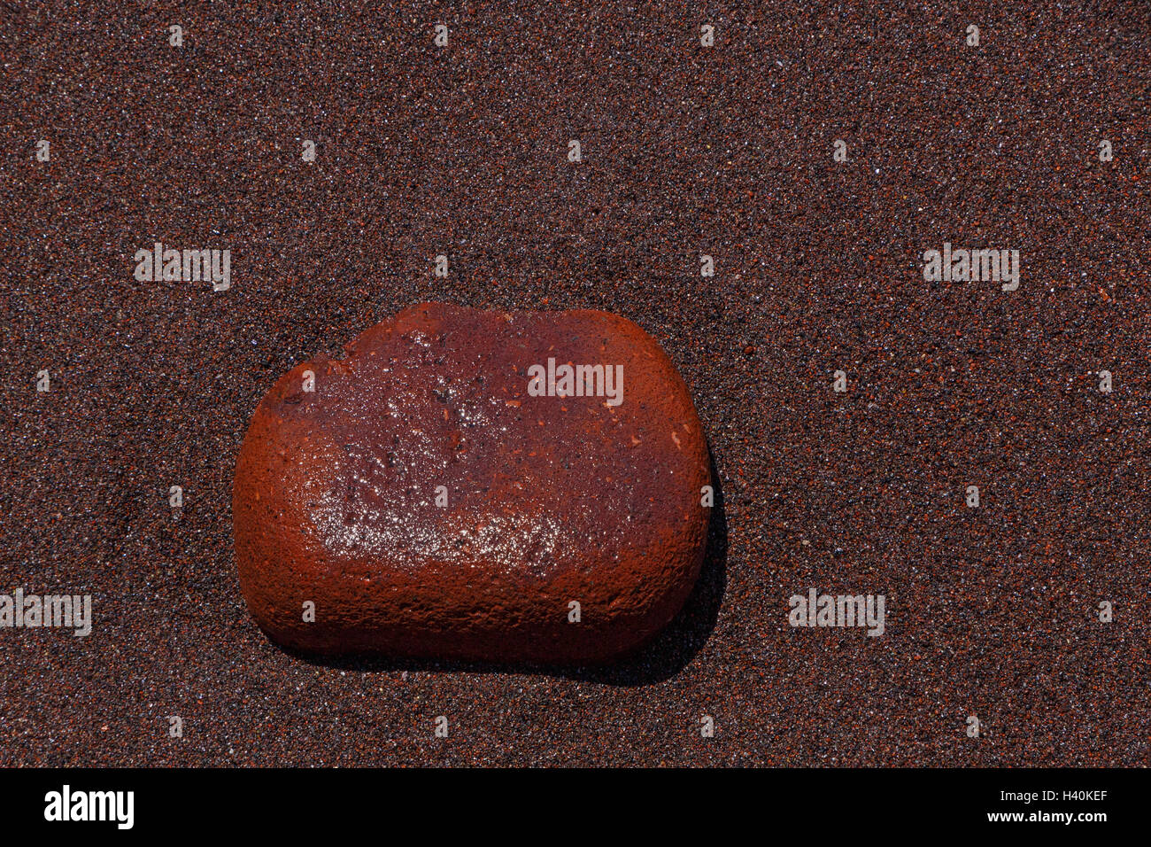 red stone on sand of Red Beach on Santorini Stock Photo - Alamy