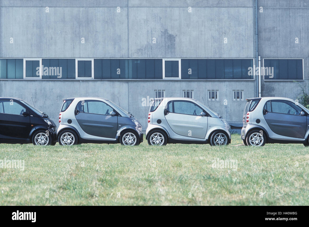 Factory buildings, detail, cars, "Smart", park, one after the other ...