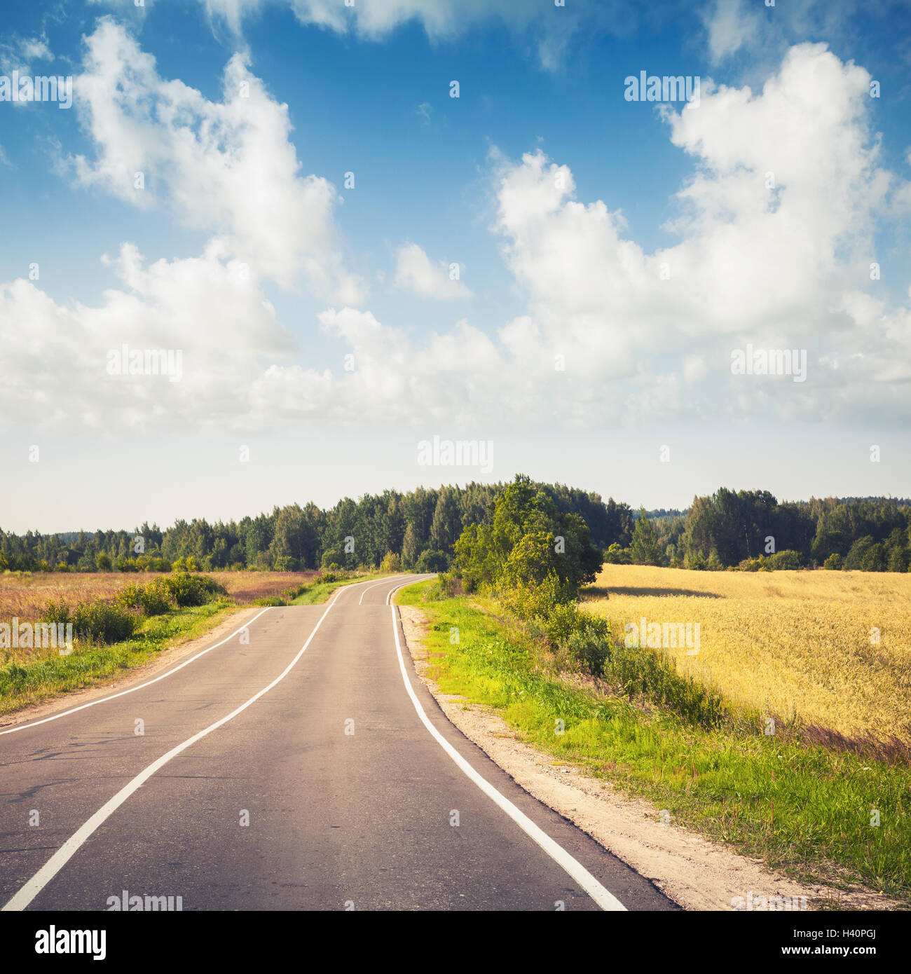 Empty turning rural highway under cloudy sky, square European road ...