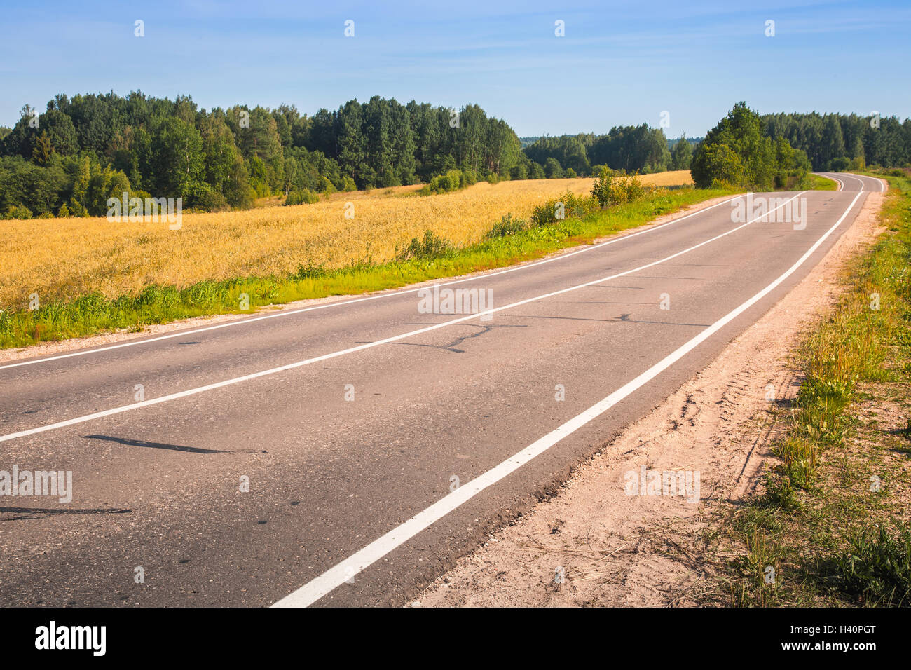 Empty turning rural highway, European road landscape Stock Photo - Alamy