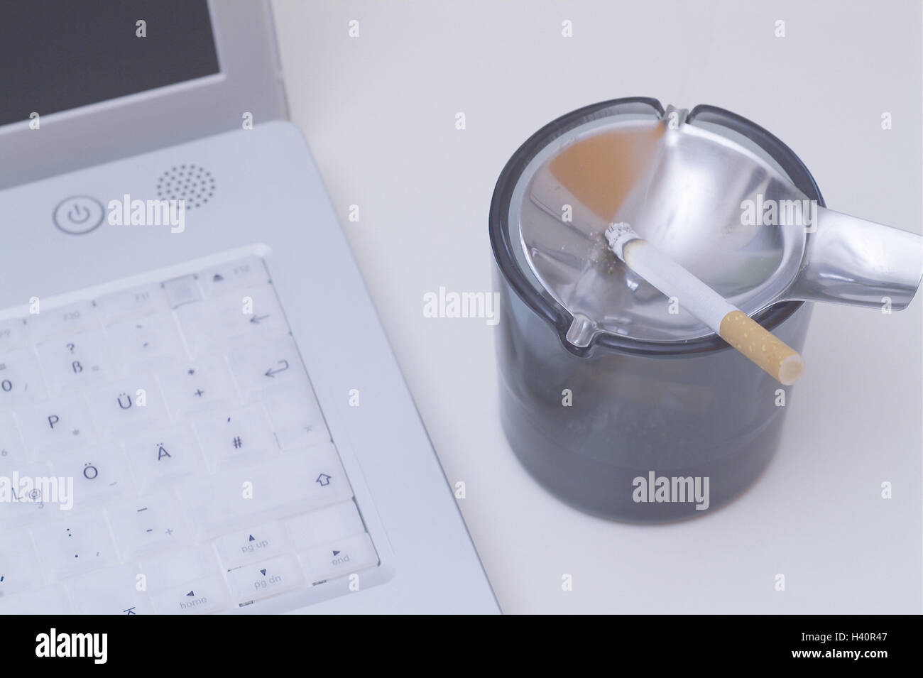 Ashtray, cigarette, laptop, detail, from above, curled, office ...