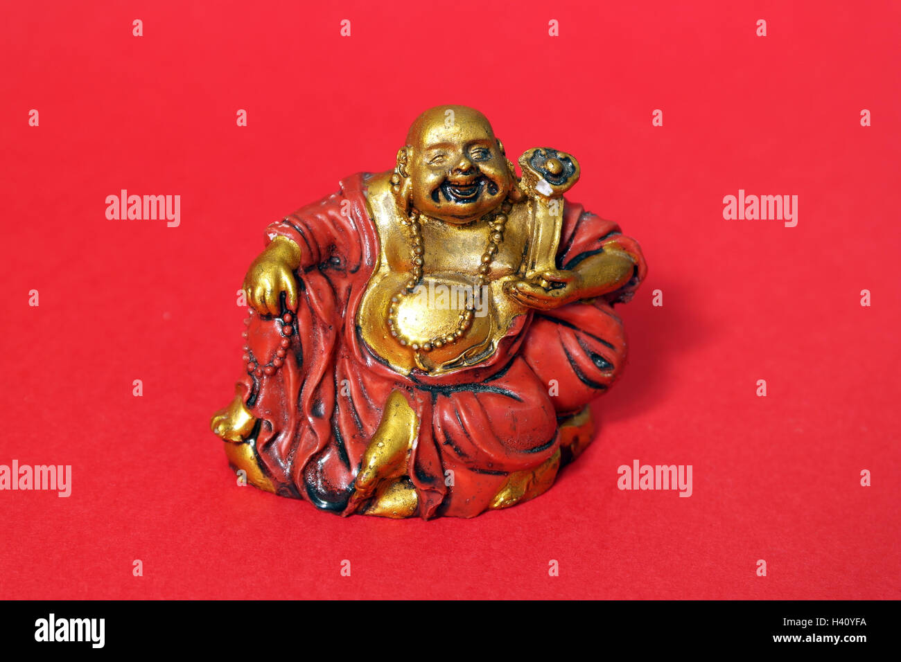 Buddha little statue with red background Stock Photo - Alamy