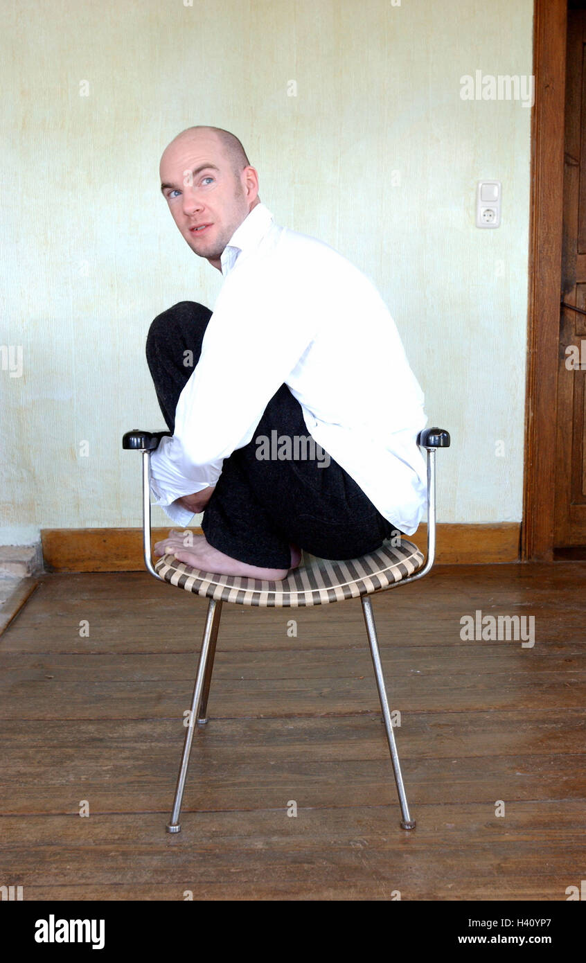 Man, young, bones drawn, chair, sit, wait side view, flat, living space ...