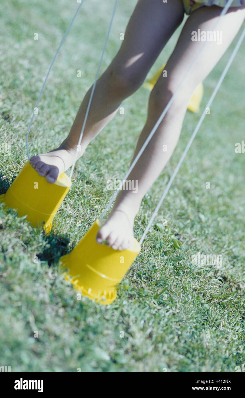 Child bucket stilts hi-res stock photography and images - Alamy