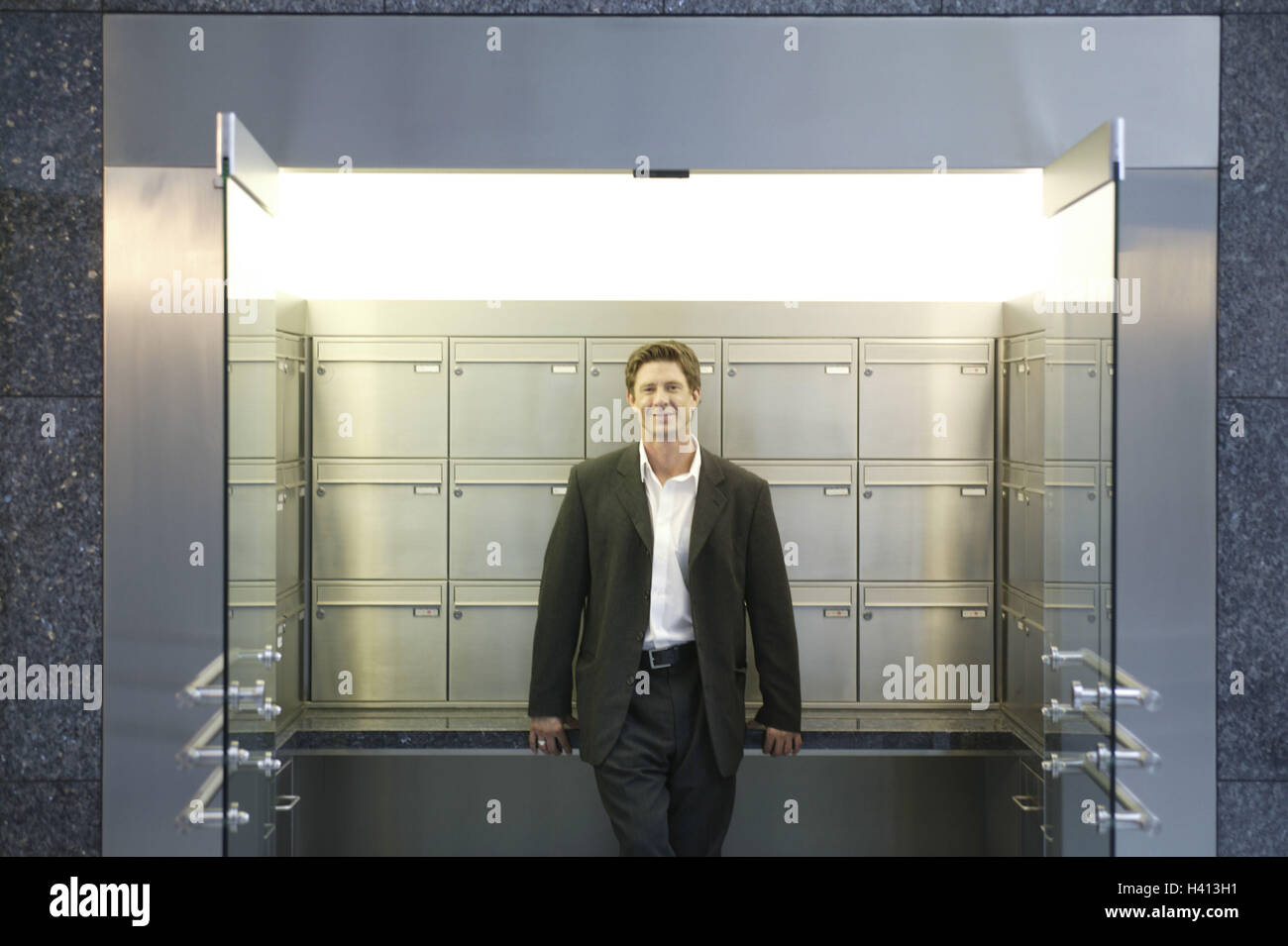 Office buildings, hall, mailboxes, man, suit, smiles Stock Photo - Alamy