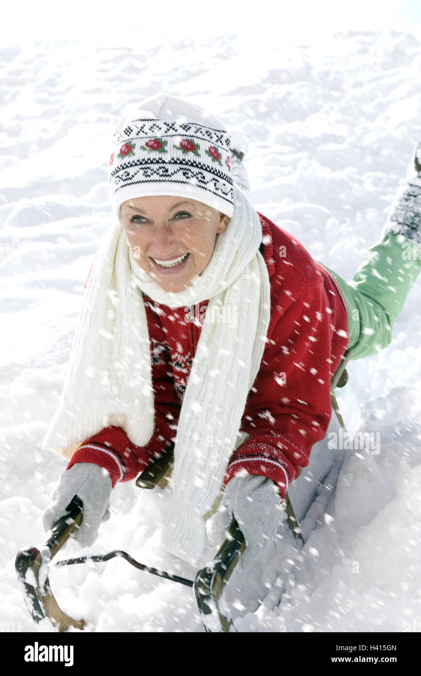 Senior, happily, sleigh-riding, abdominal position, portrait, woman ...