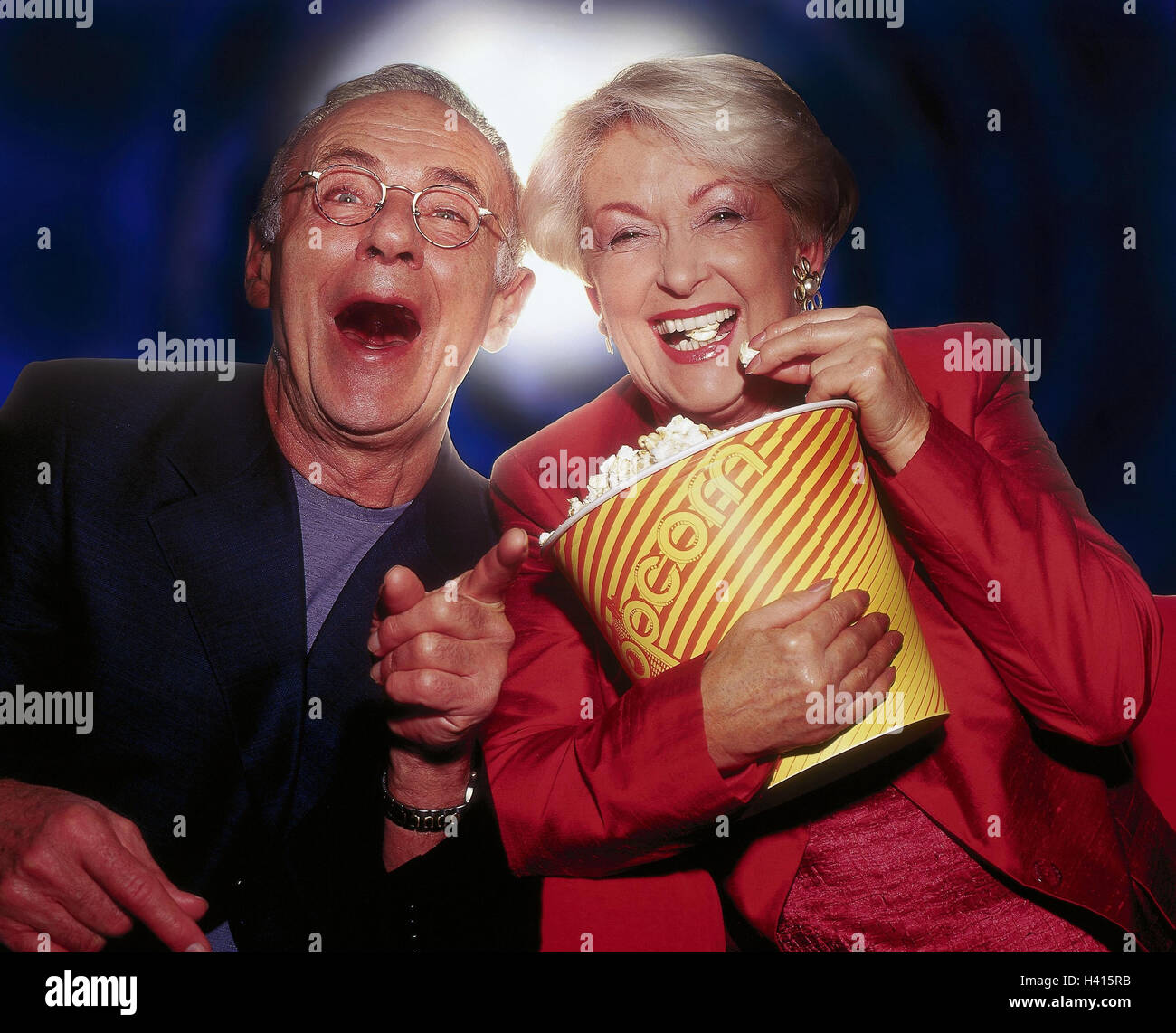 Cinema, Senior couple, popcorn, eat, laugh, fun, gesture, point Senior ...