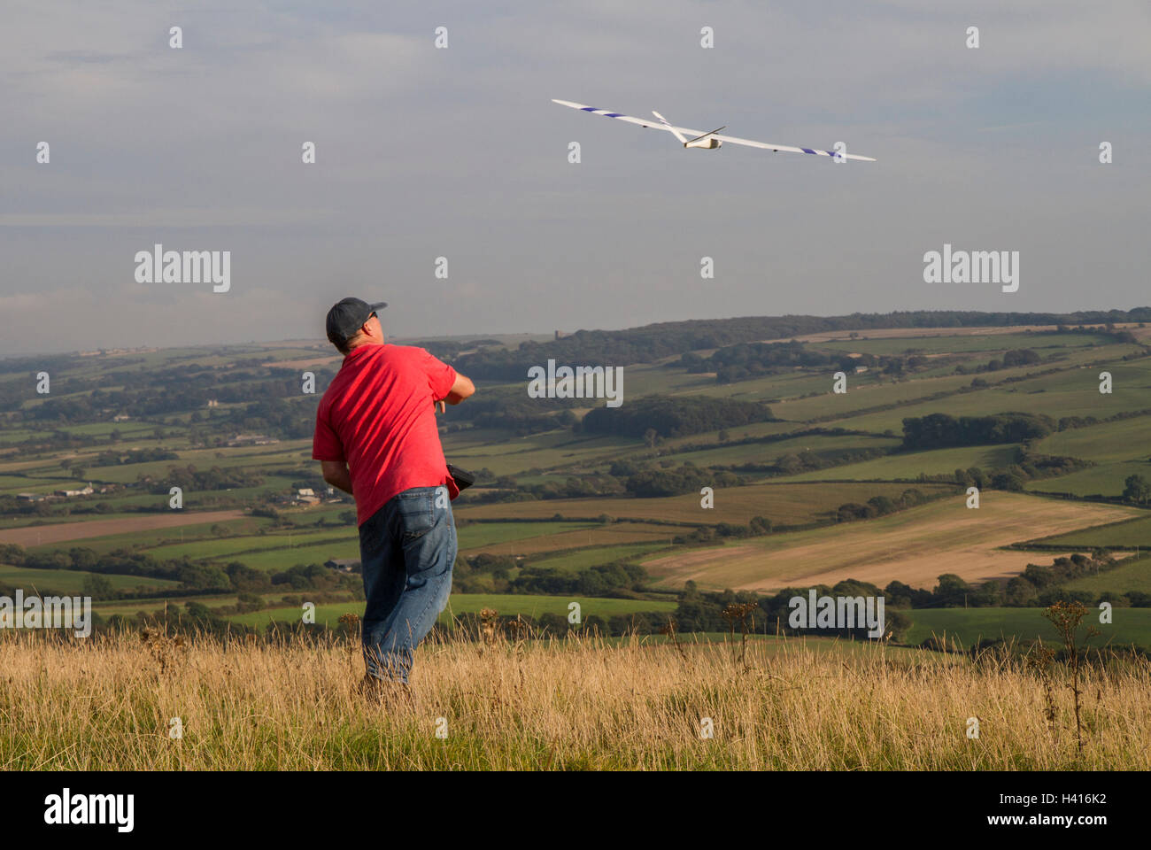 man throwing off model plane over beautiful English countryside Stock ...