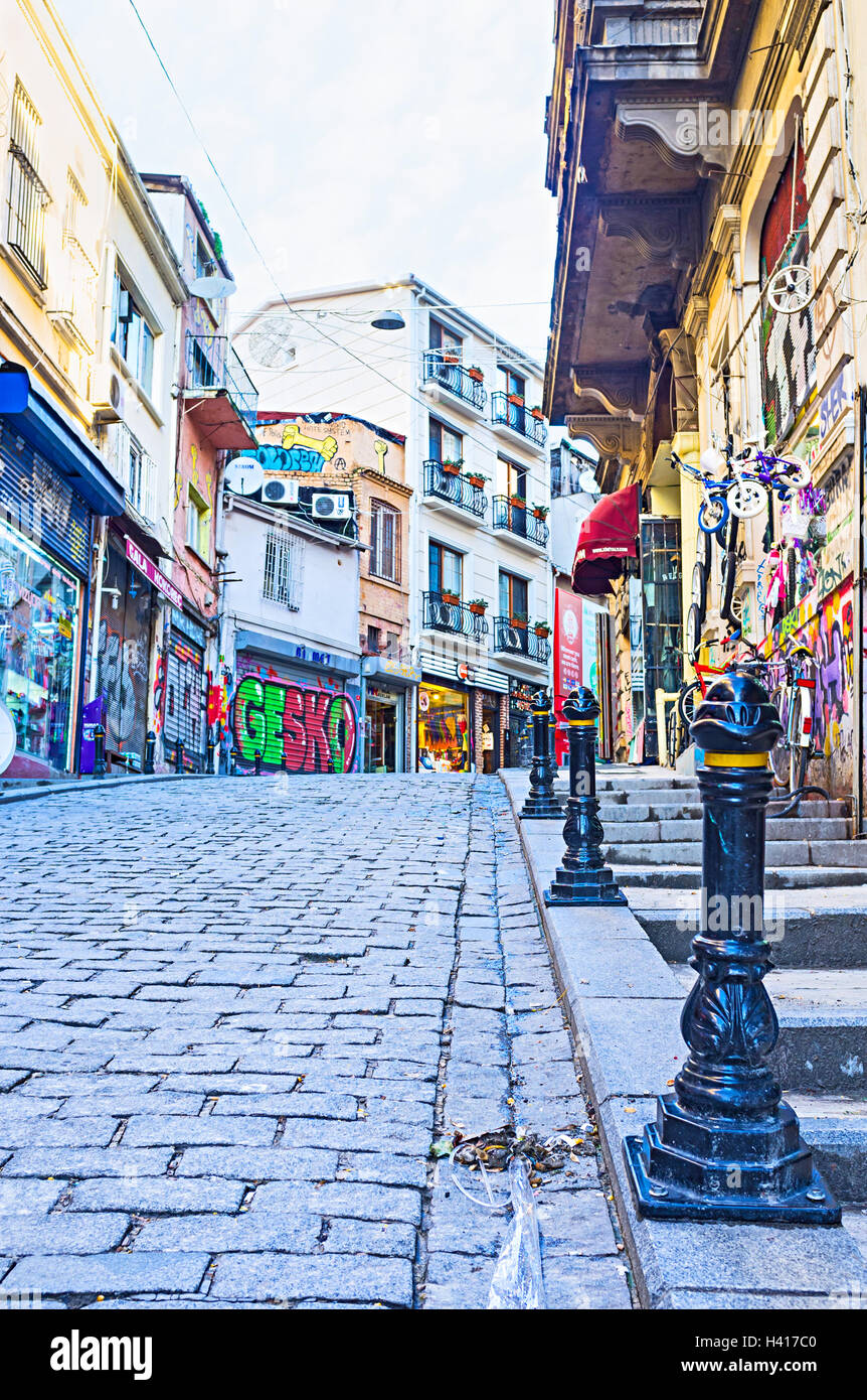 The old shopping street with colorful graffiti on the building walls ...