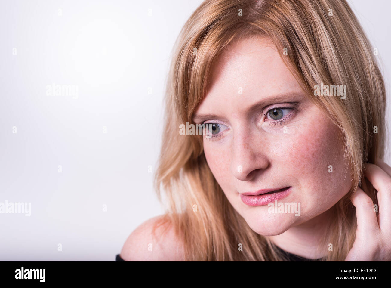 Blonde woman looking down hi-res stock photography and images - Alamy