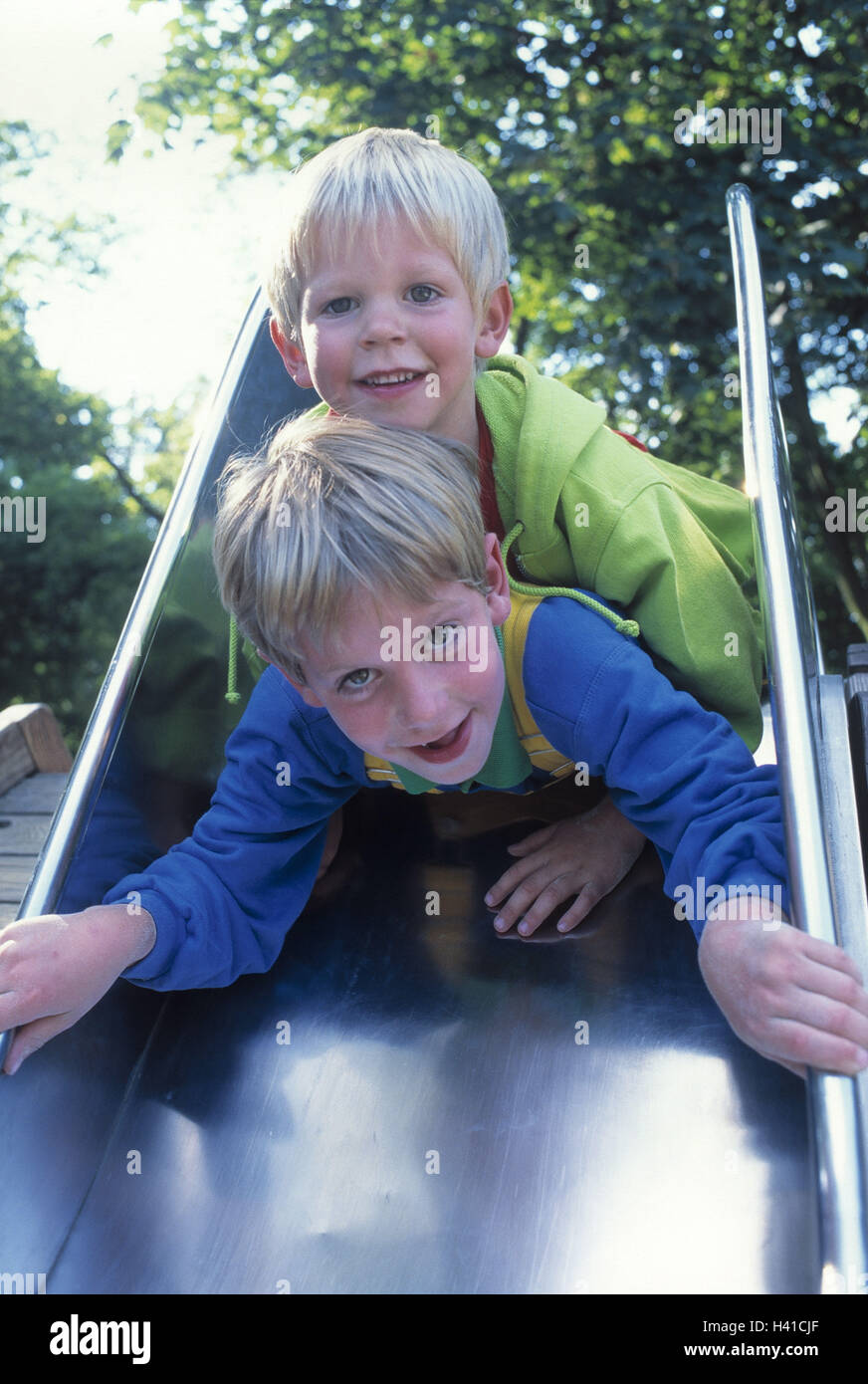 Children's slide, detail, boy, lie, rave about one another, portrait ...