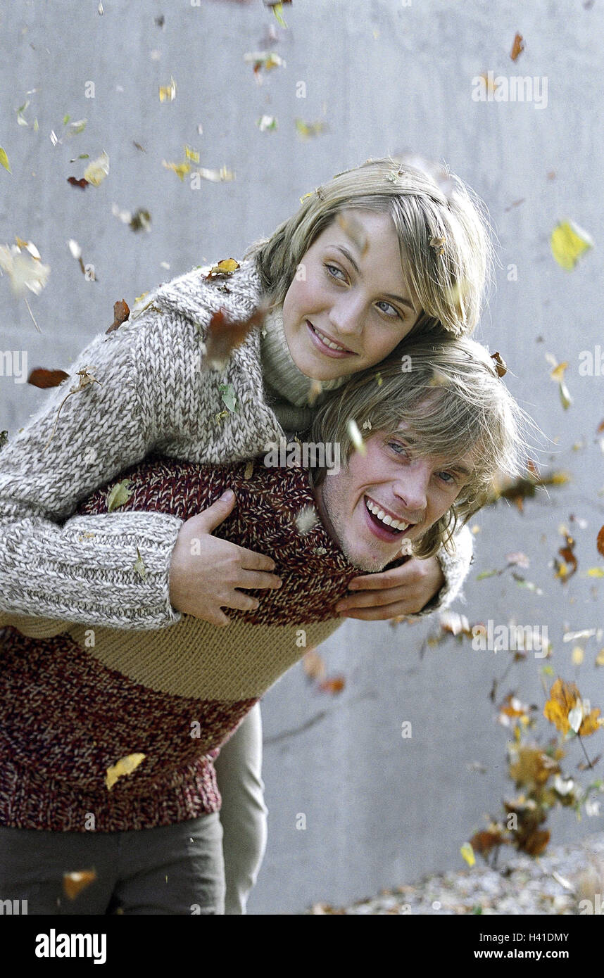 Couple, young, happy, pickaback, autumn foliage, half portrait, side ...