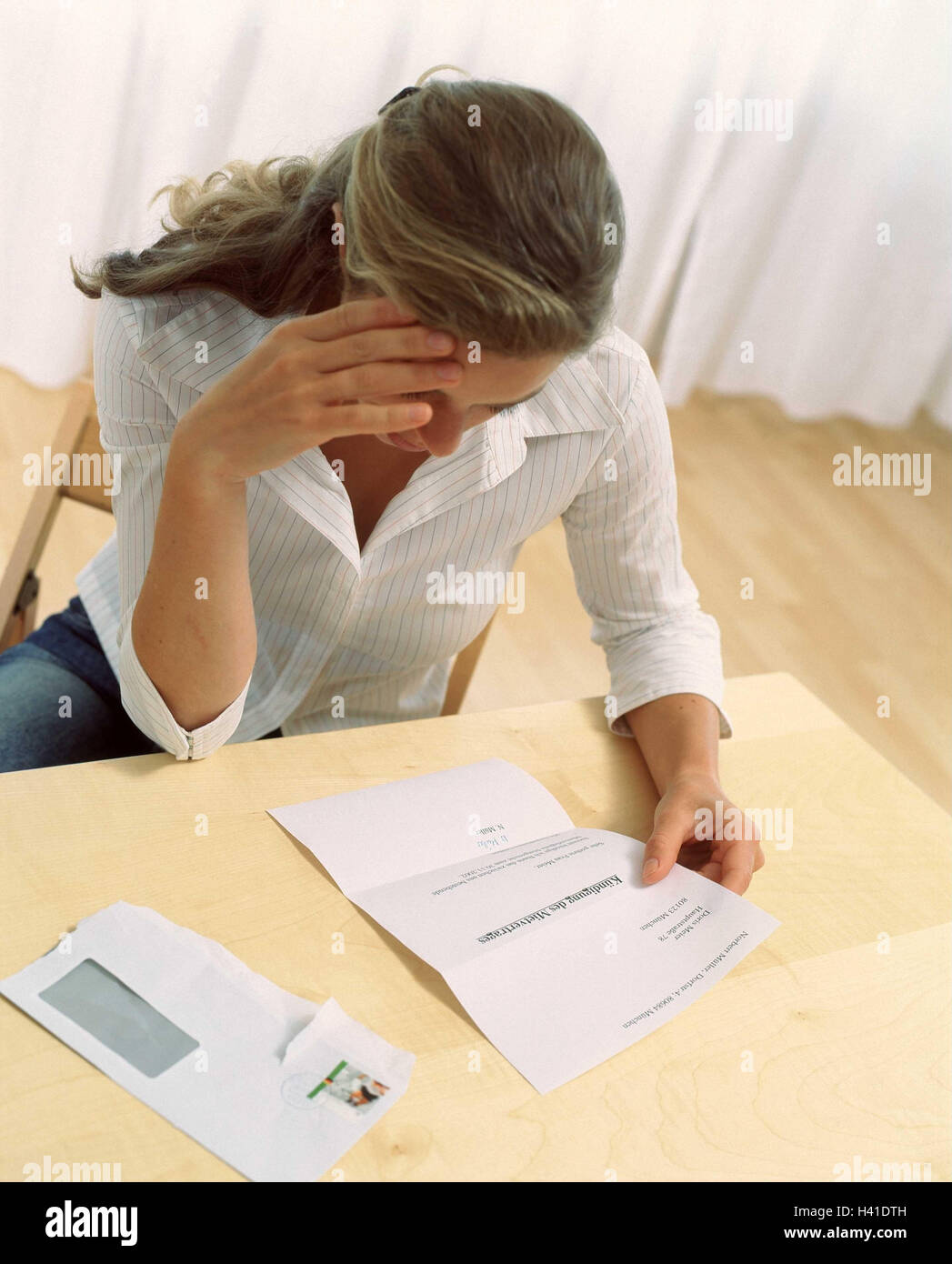 Woman, sadly, letter, notice, read inside, at home, young, gesture, is ...