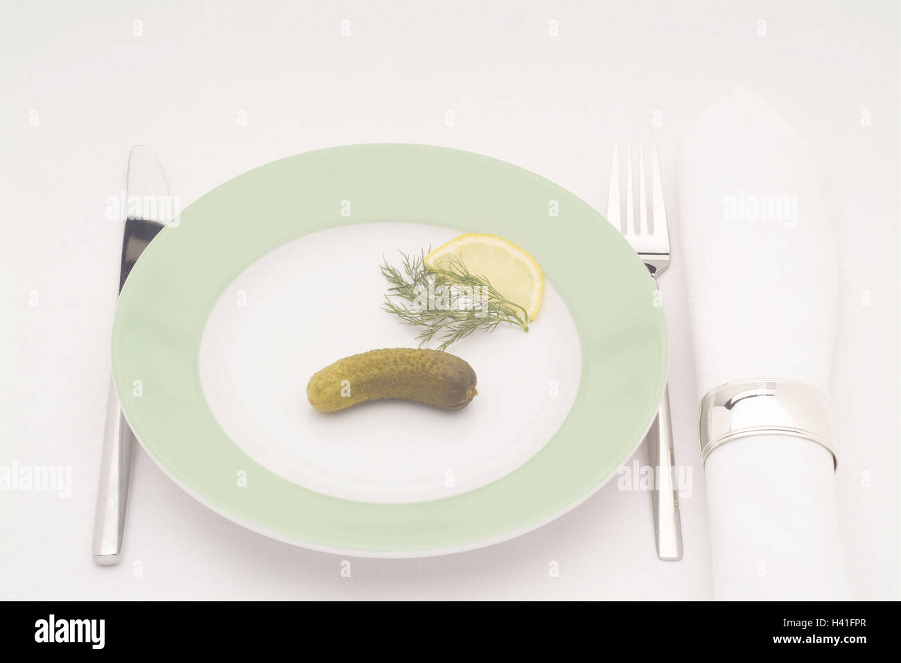 Plate, gherkin, slice lemon, dill, instruments, napkin, eating plate ...