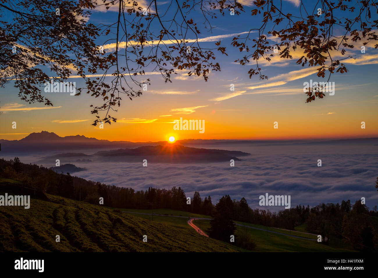 Fog surrounding town Zug and Zugersee during the sunset with the ...