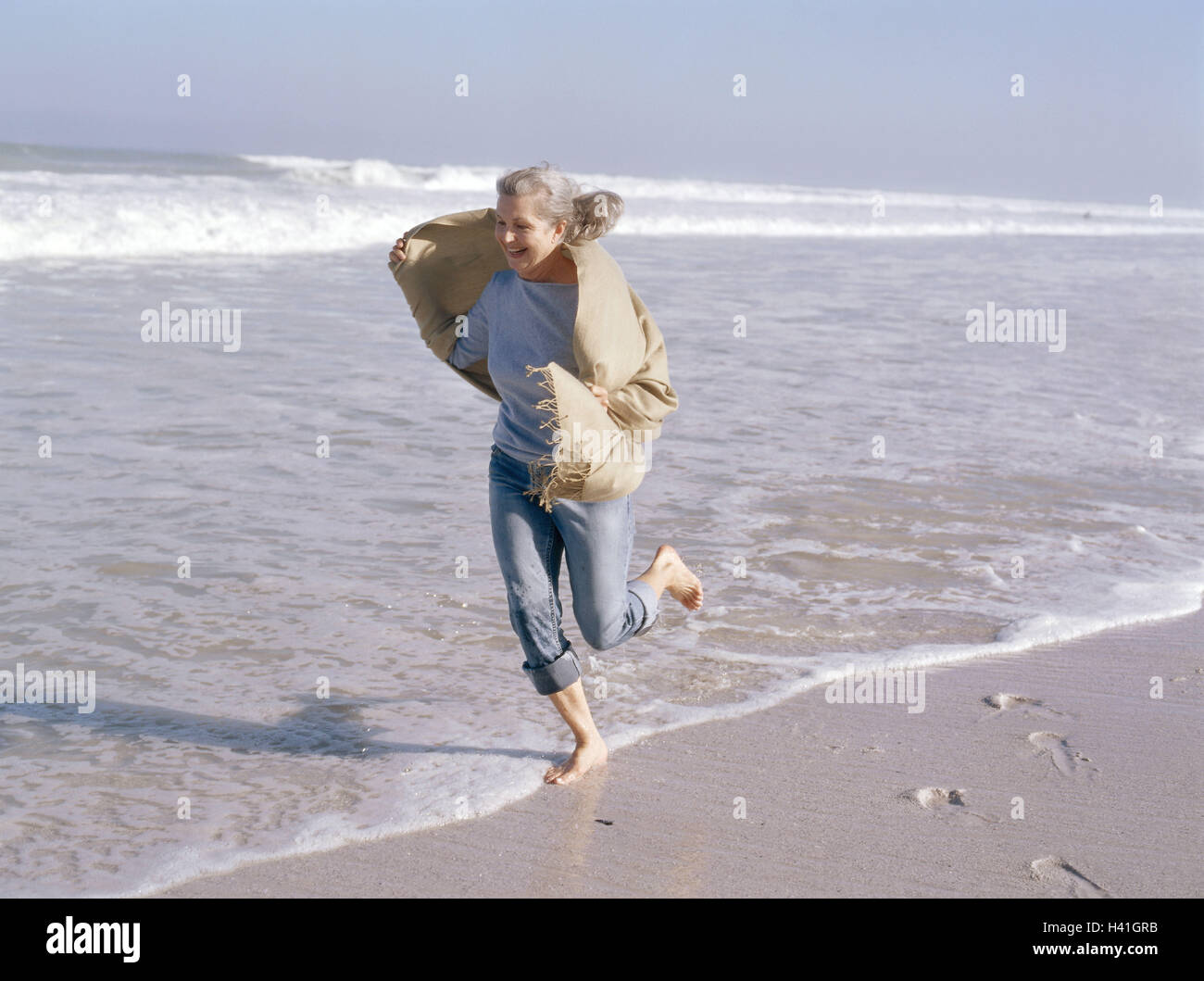 Sandy beach, sea, senior, happy, Land on water shallow, runs, at the ...