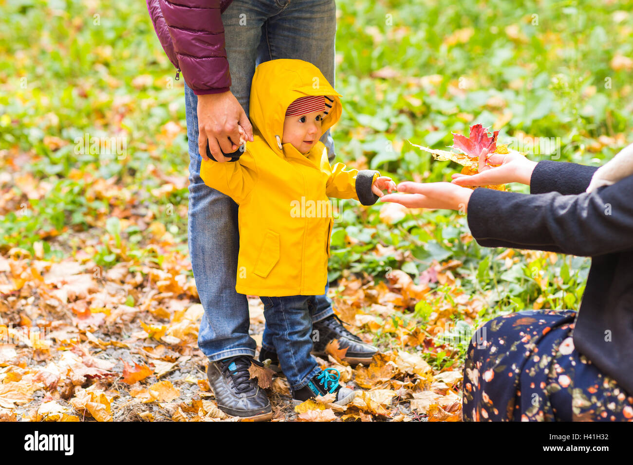 Father, mother and Son walking. Baby taking first steps with father ...