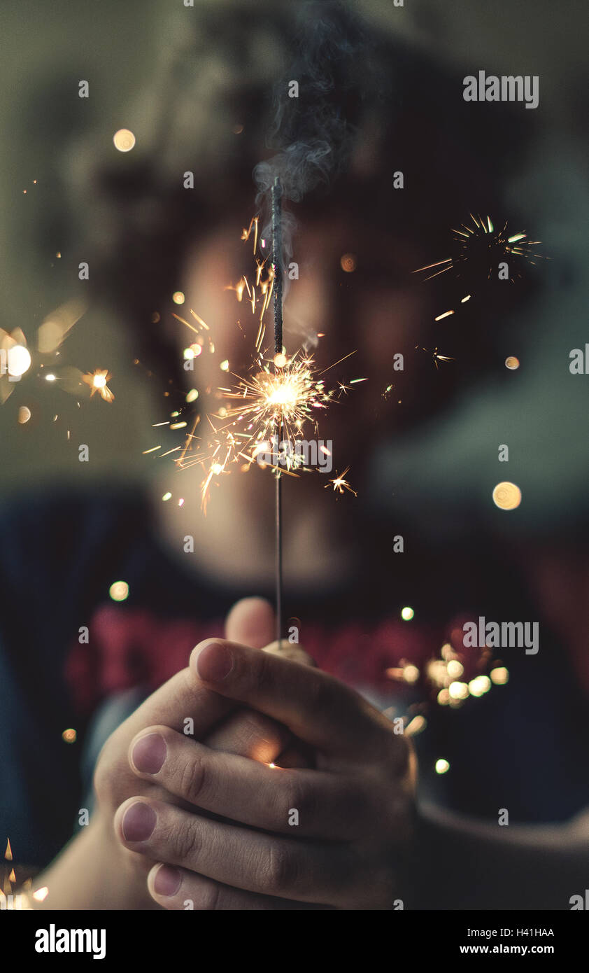 Boy holding a sparkler Stock Photo - Alamy