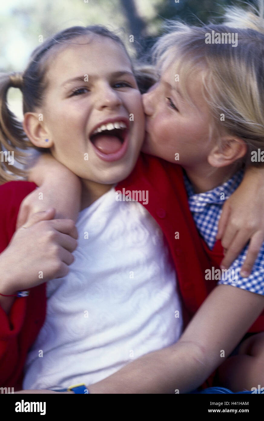 Girls, embrace, kiss, blur, very close, outside, leisure time ...