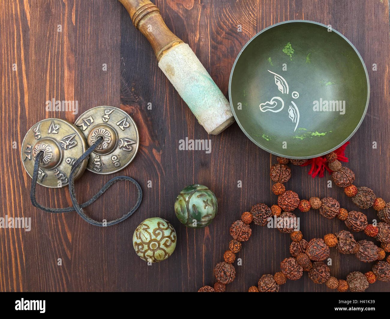 Tibetan singing bowl and objects for religious ritual, on a brown ...