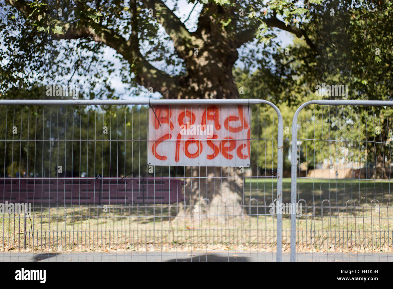 'Road Closed' spray-painted sign on barrier surrounding road works in ...