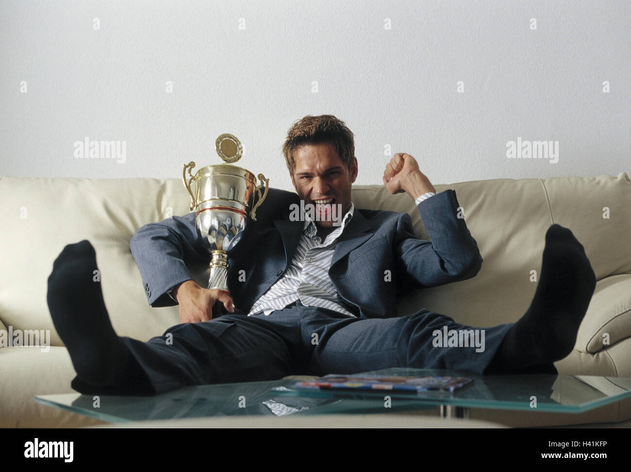 Man, sit young, sofa, cup, gesture, victory, success couch, winner's ...