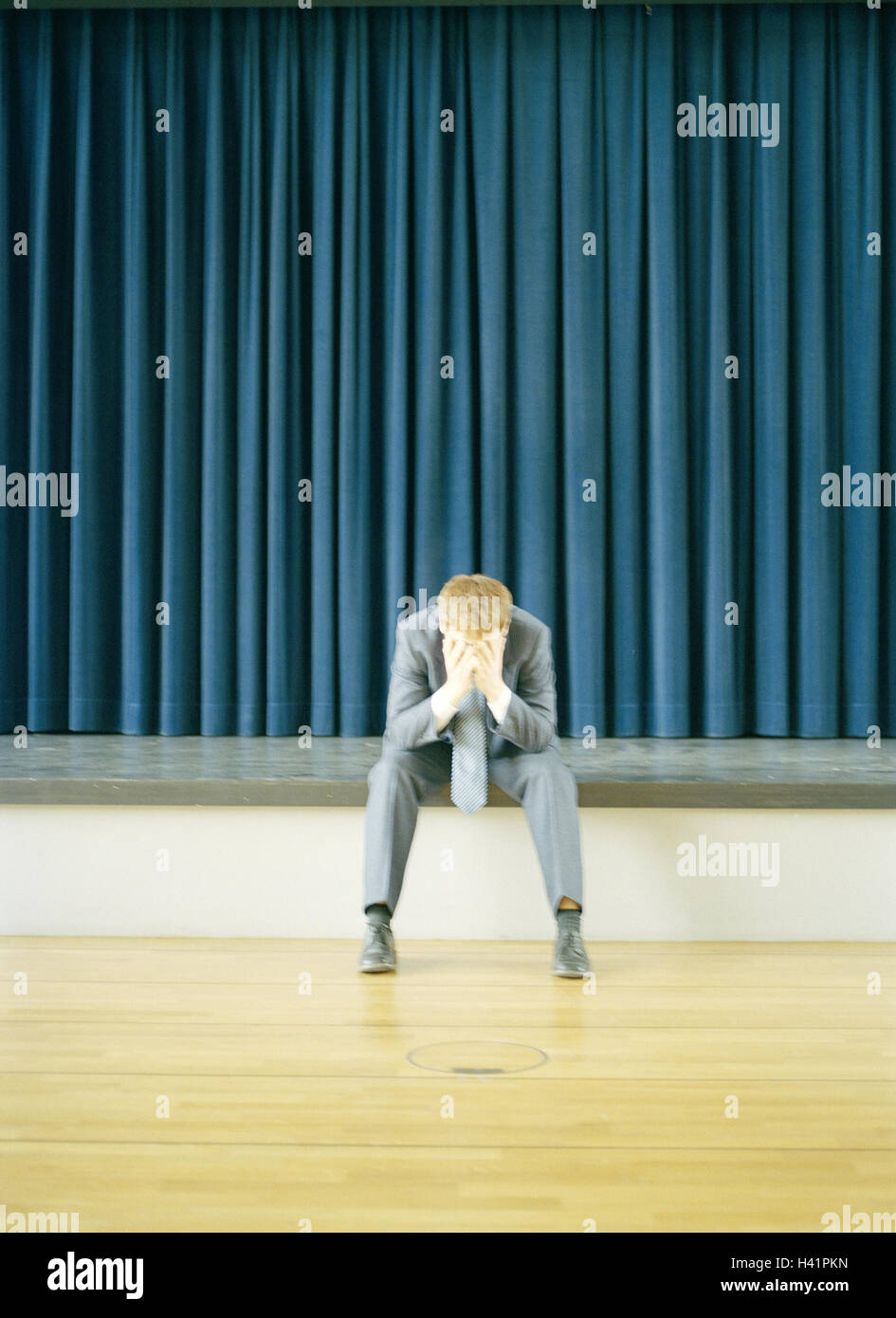Film set, curtain, man, suit, sit, refuse to gesture, desperation, blur ...