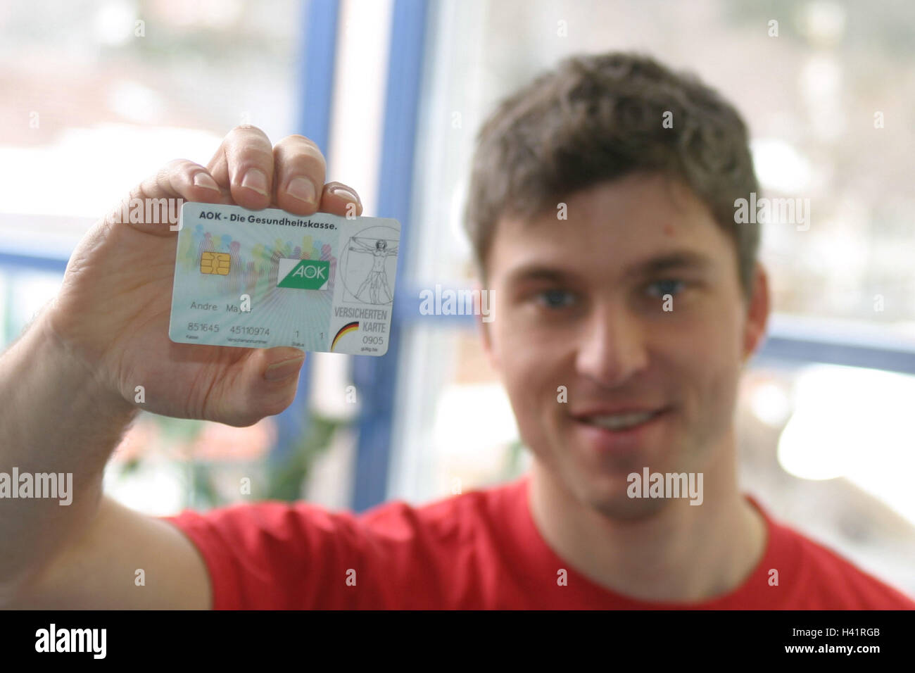 Man, young, health insurance card, Aok, hold, blur, portrait, patient ...