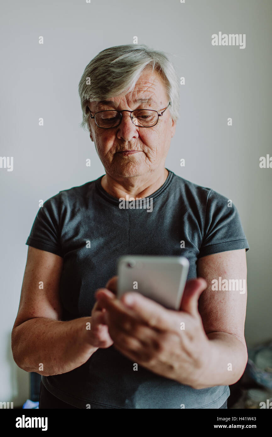 Senior woman using a mobile phone Stock Photo - Alamy