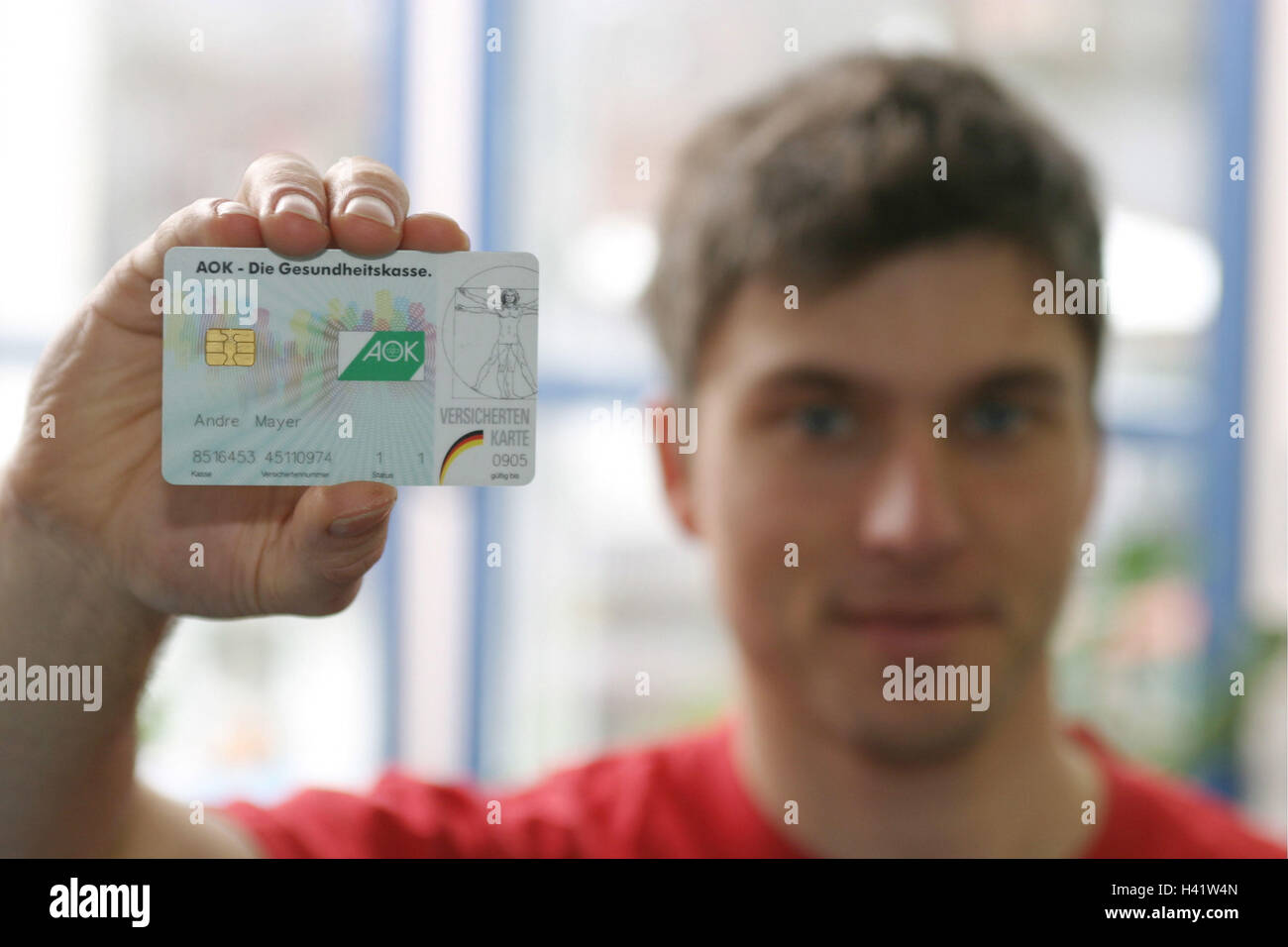 Man, young, health insurance card, Aok, hold, blur, portrait, patient ...