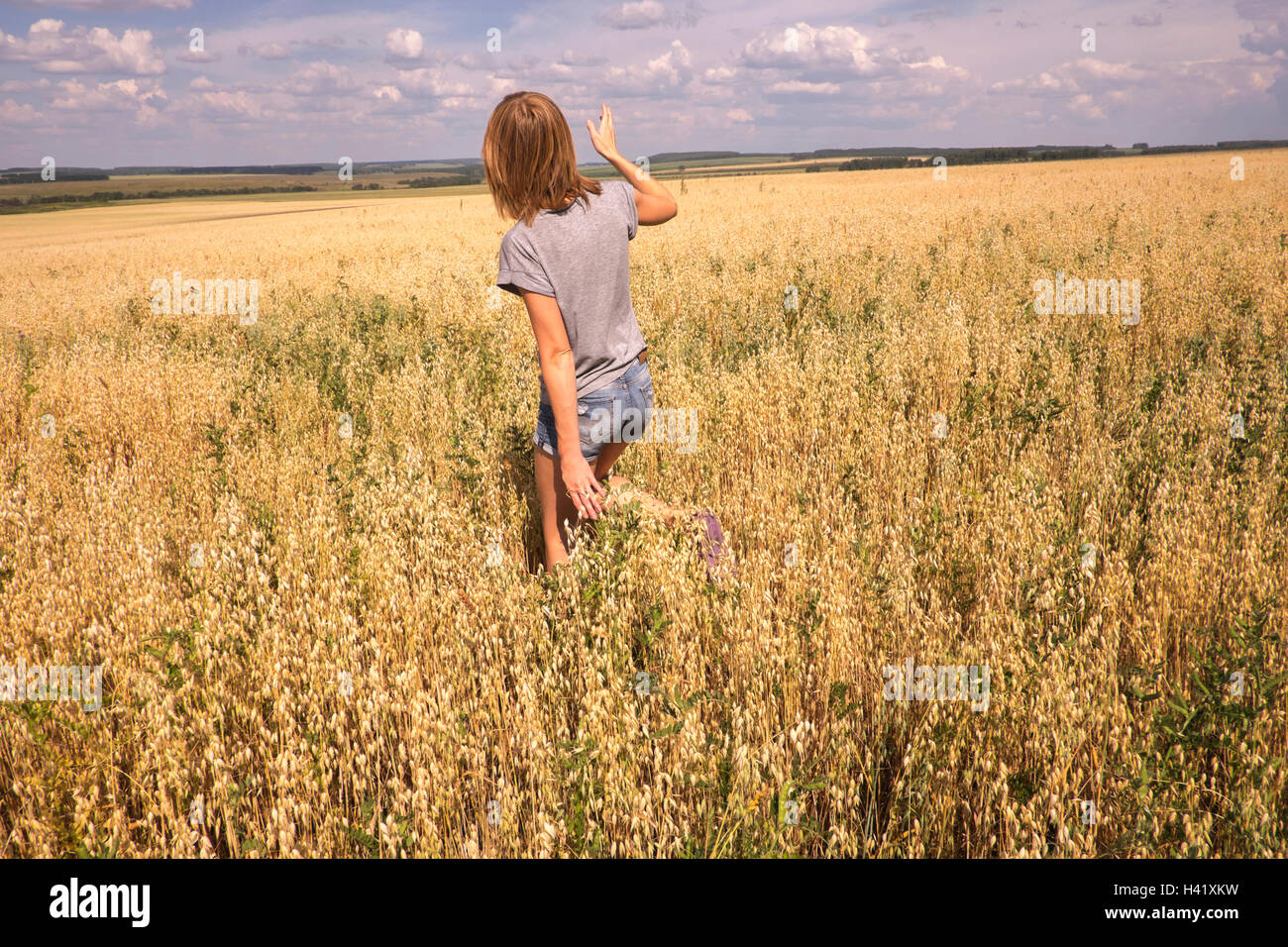 Caucasian woman walking in field Stock Photo - Alamy