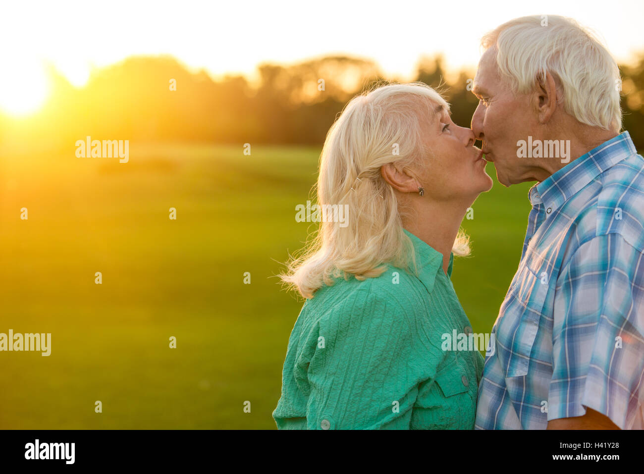 Senior couple is kissing Stock Photo - Alamy