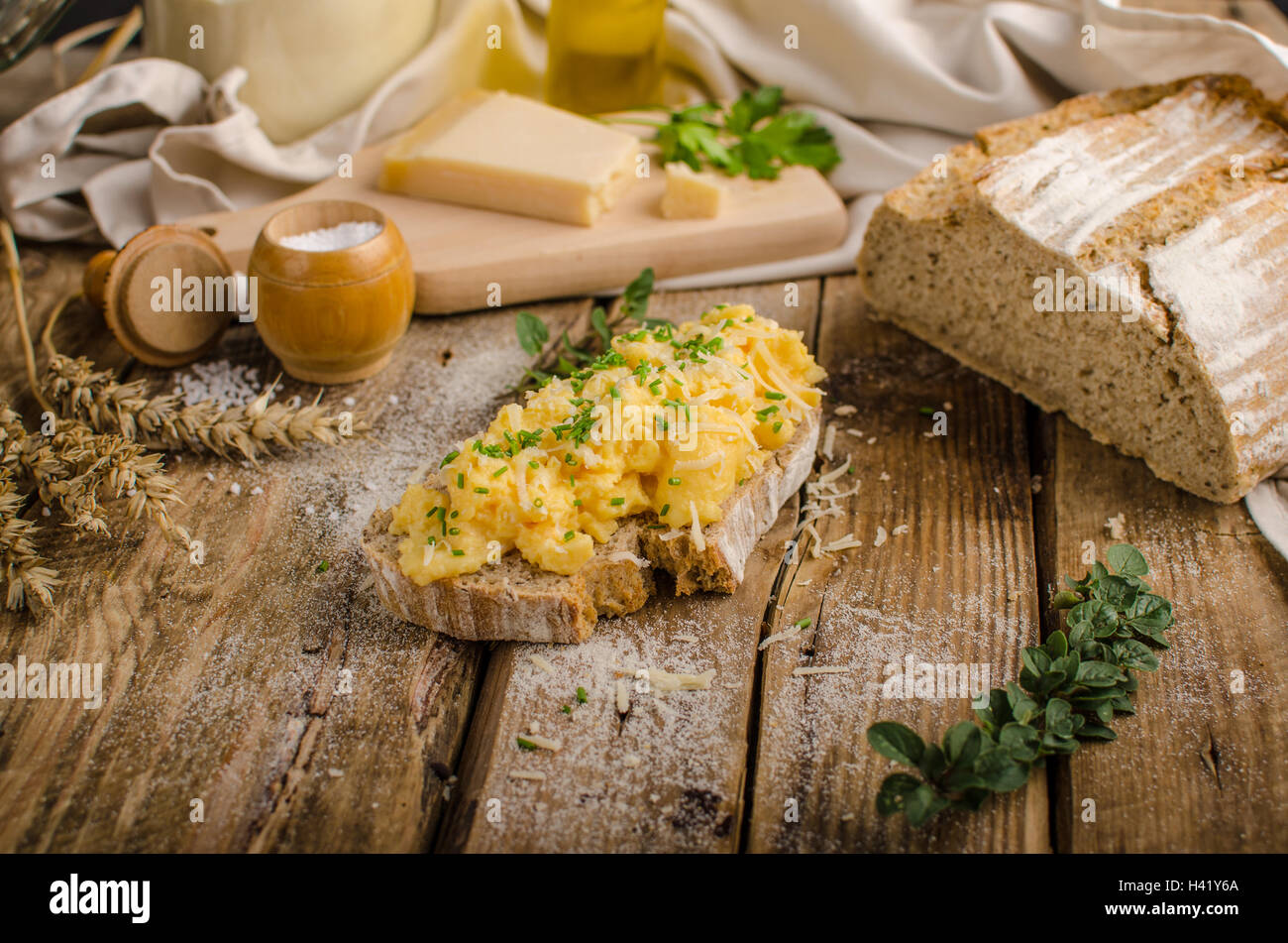 Scrambled eggs on homemade bread, beautiful rustic bread baked home in ...