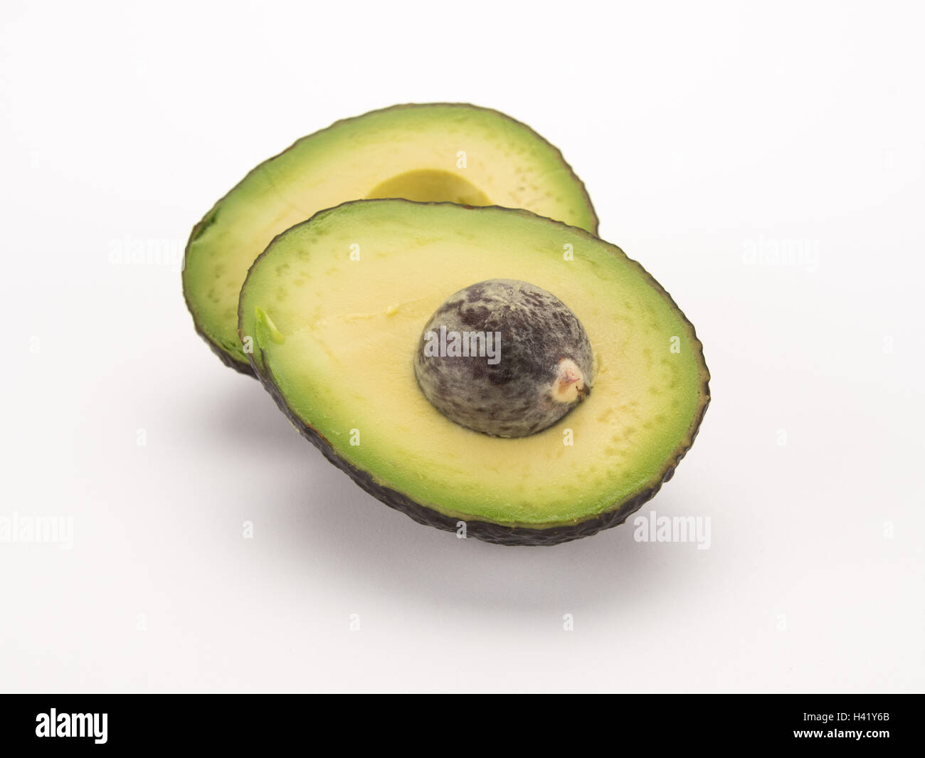 Avocado Split with Pit in tact isolated on white background Stock Photo ...