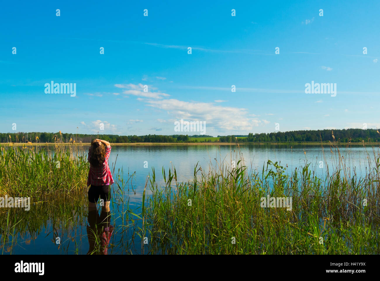 Caucasian woman wading in river Stock Photo - Alamy