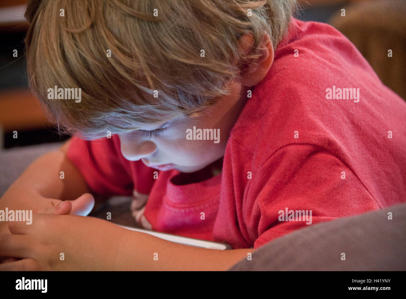 Serious kid holding smart phone hi-res stock photography and images - Alamy