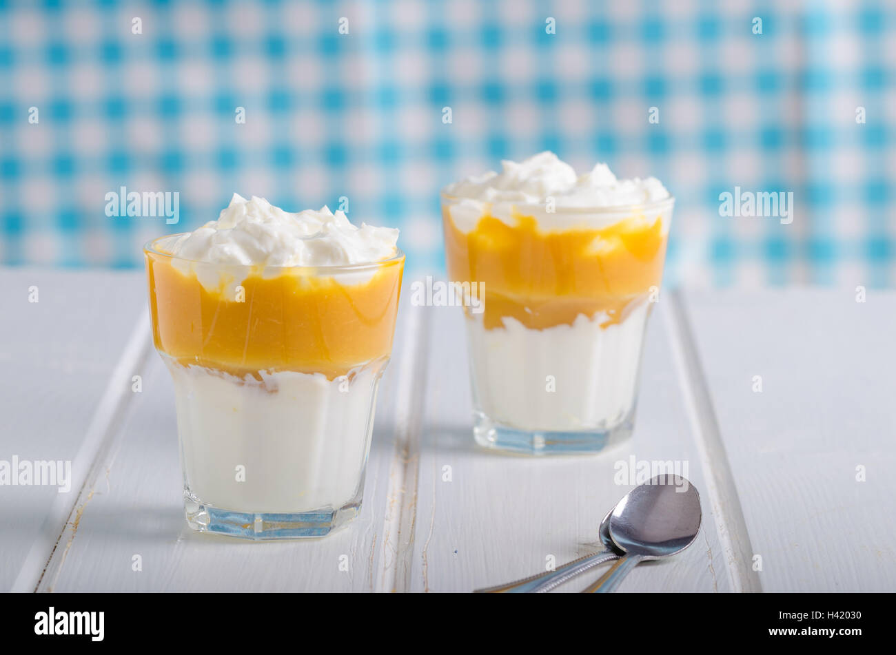 Fresh cottage cheese with peach puree with homemade whipped cream Stock ...