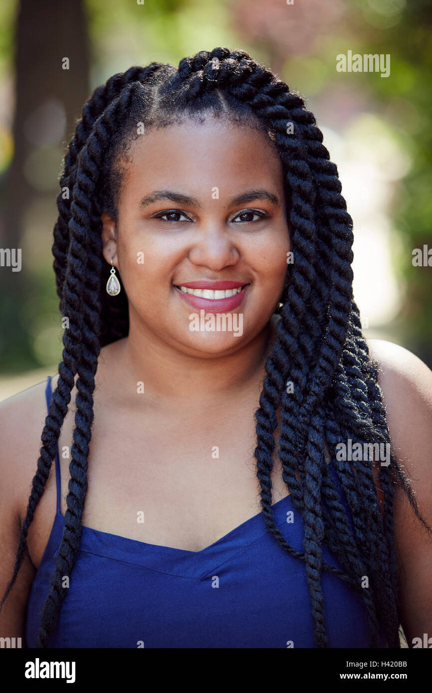 Smiling black woman with braids Stock Photo - Alamy