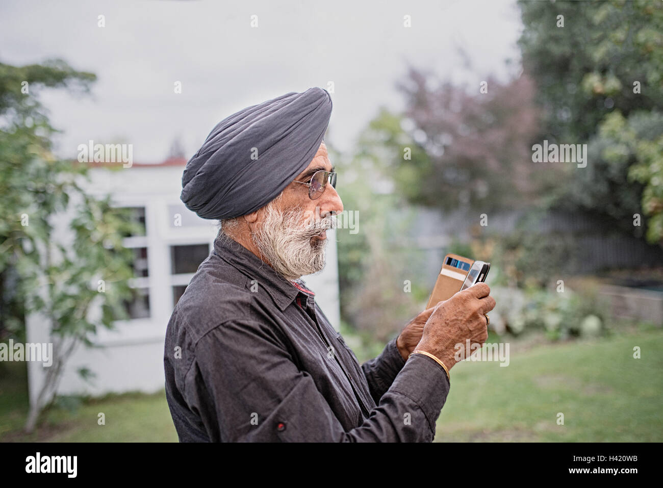 Indian man texting on cell phone Stock Photo - Alamy